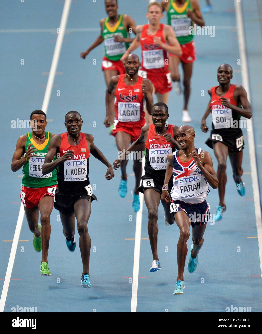 Britain's Mo Farah, right, looks back at Kenya's Isiah Kiplangat Koech ...