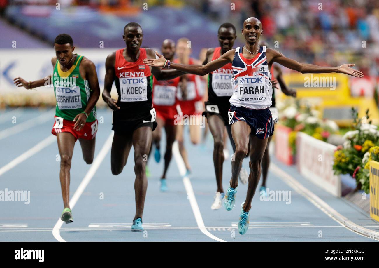 Britain's Mo Farah, right, crosses the finish line to win the men's ...