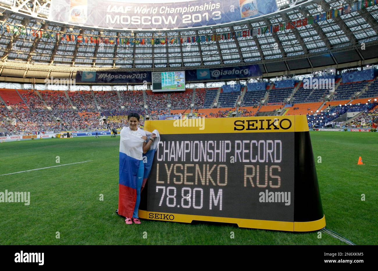 Russia's Tatyana Lysenko poses with the national flag next to the score ...