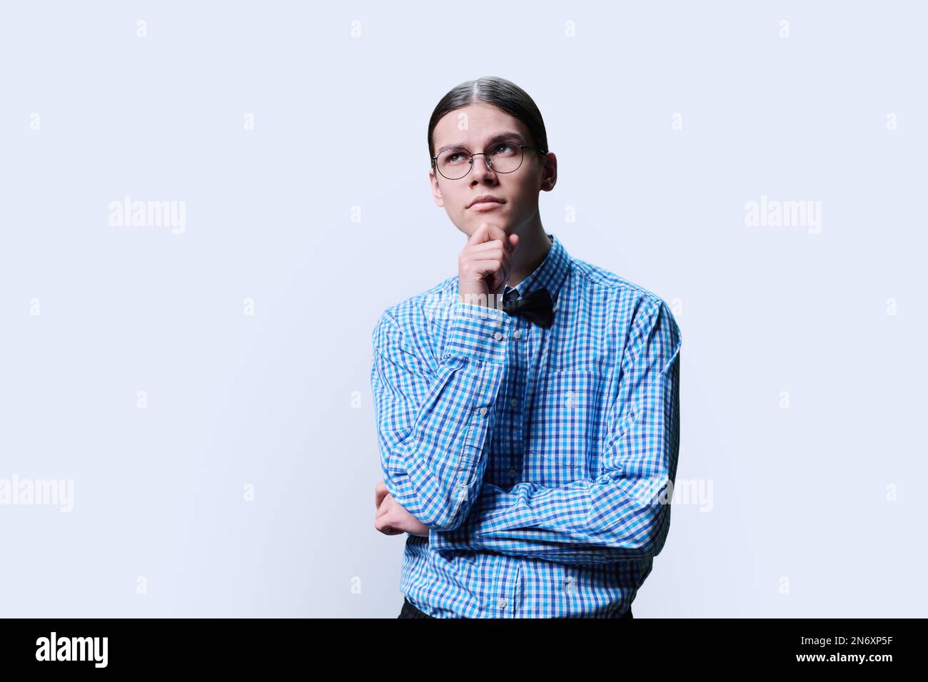 Dreaming teenage male student on white studio background Stock Photo ...
