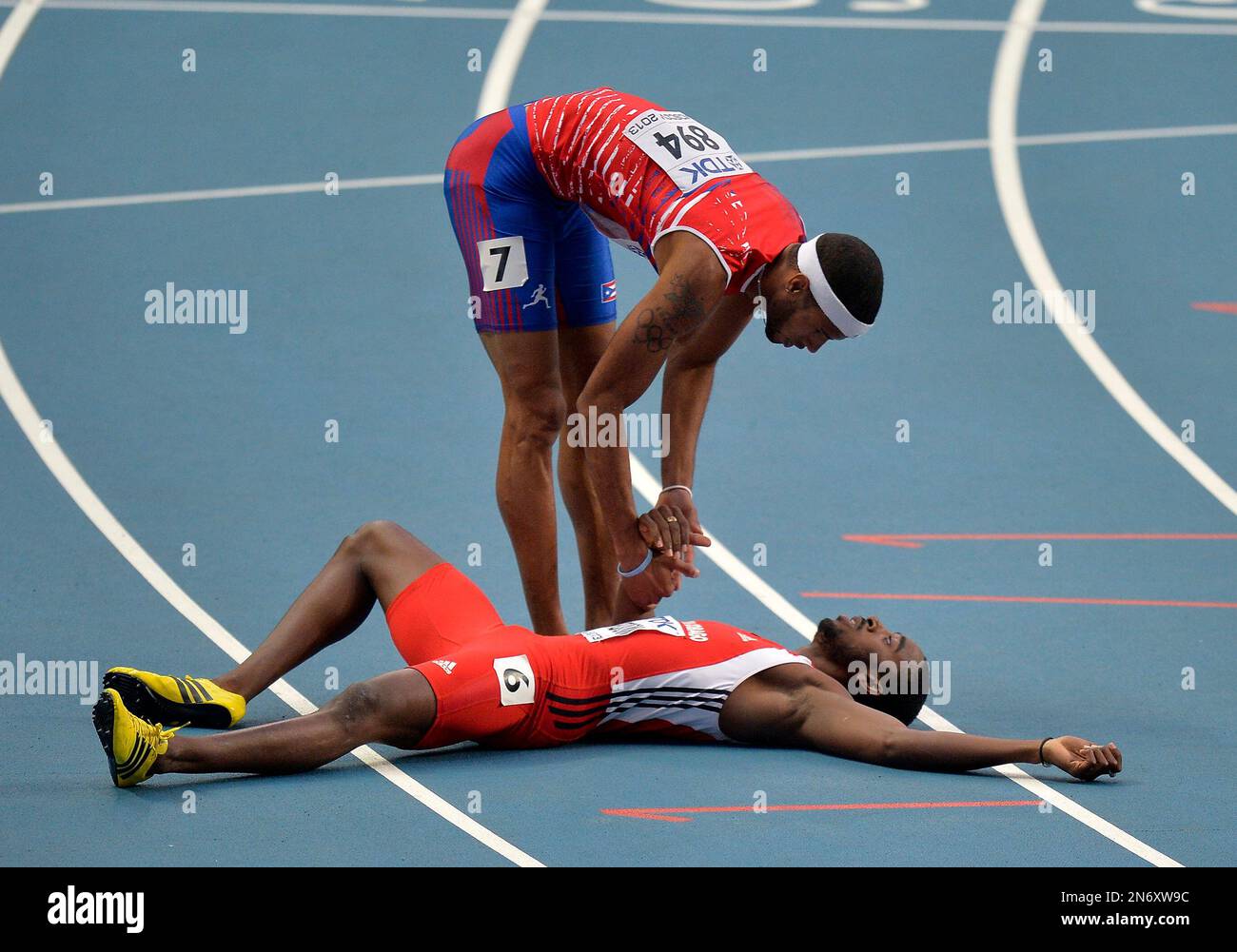 Trinidad and Tobago's Jehue Gordon, on track, is congratulated by ...