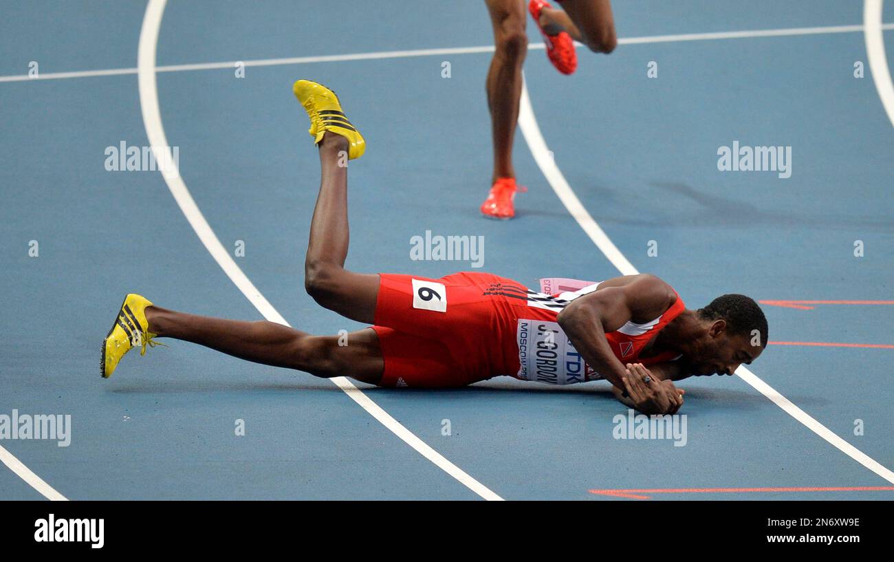 Trinidad and Tobago's Jehue Gordon falls after crossing the finish line ...