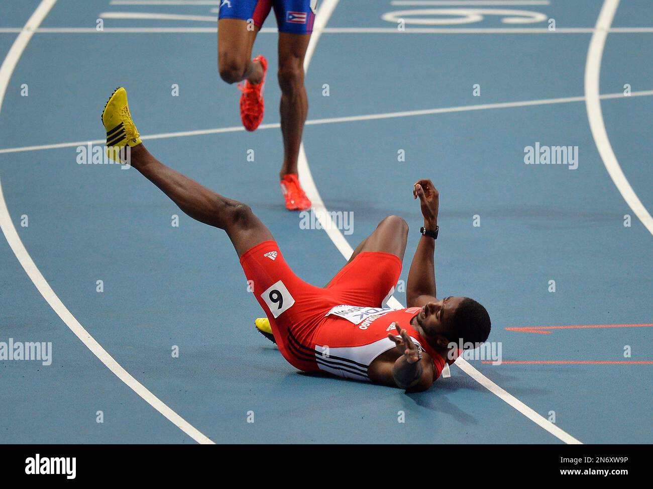Trinidad and Tobago's Jehue Gordon falls after crossing the finish line ...