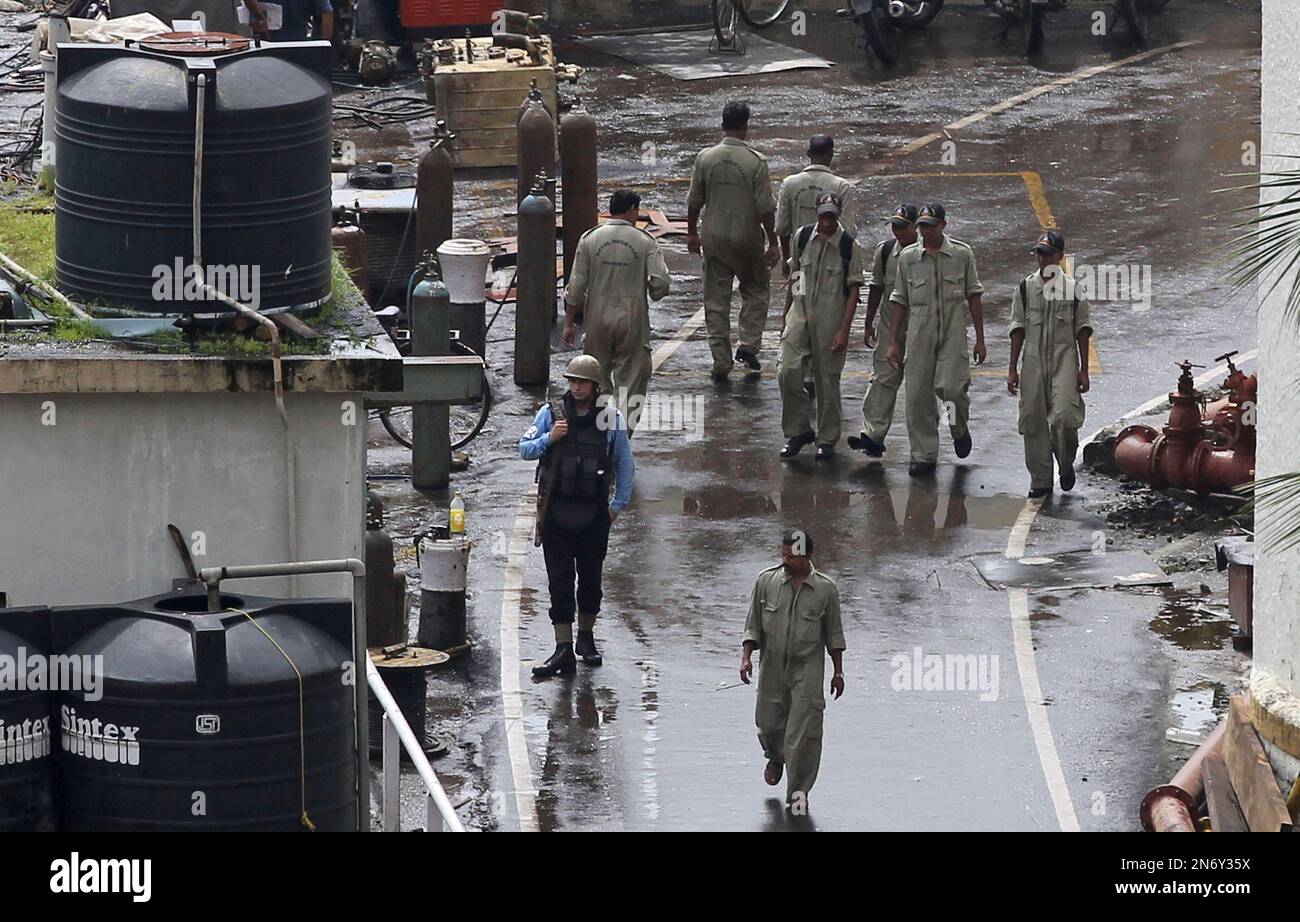 Indian navy sailors walk at the naval dockyard where a submarine caught ...