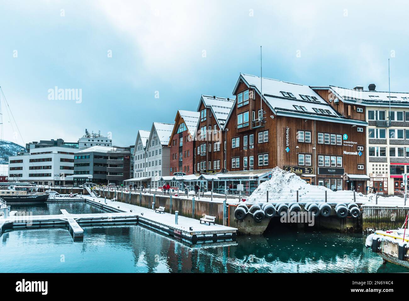 Tromso harbour, Norway, March 3rd 2022: Pier and traditional and new ...