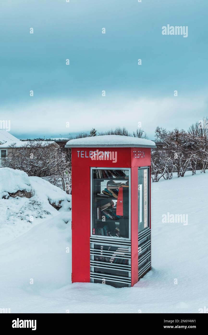 Tromso, Norway, March 3rd 2022: Old red phone box in the snow in Tromso ...