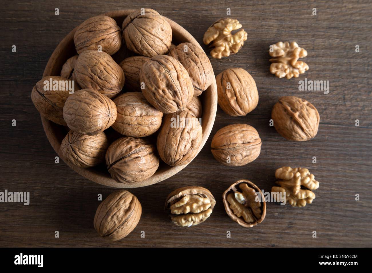A bowl of peeled walnuts and a group of shelled walnuts,fresh nuts ...