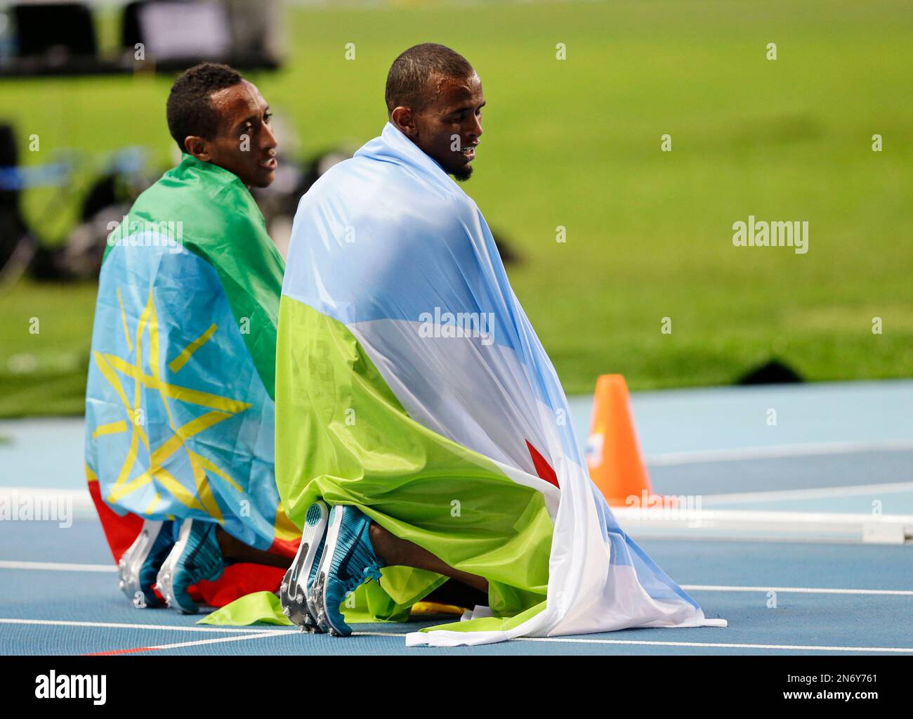 Ethiopia's Mohammed Aman, left, and Djibouti's Ayanleh Souleiman kneel ...