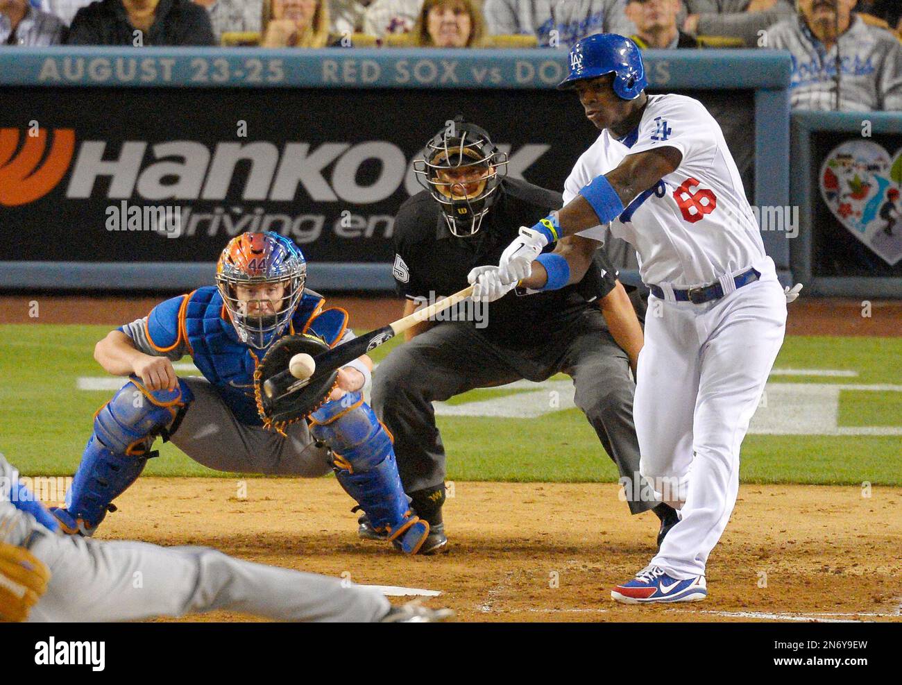 Los Angeles Dodgers' Yasiel Puig, right, hits a sacrifice fly that ...