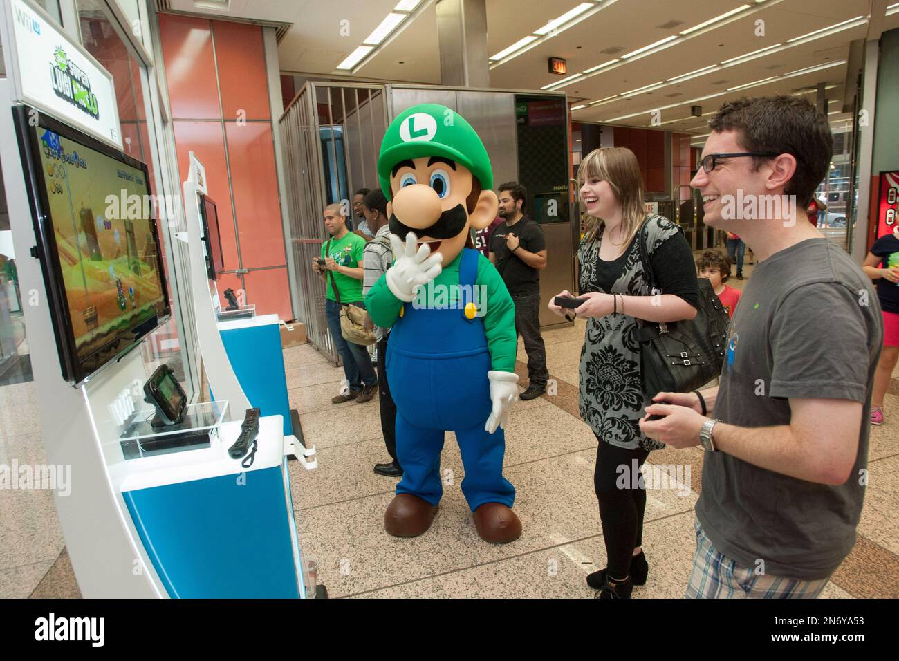 In this photo provided by Nintendo of America, commuters enjoy playing ...