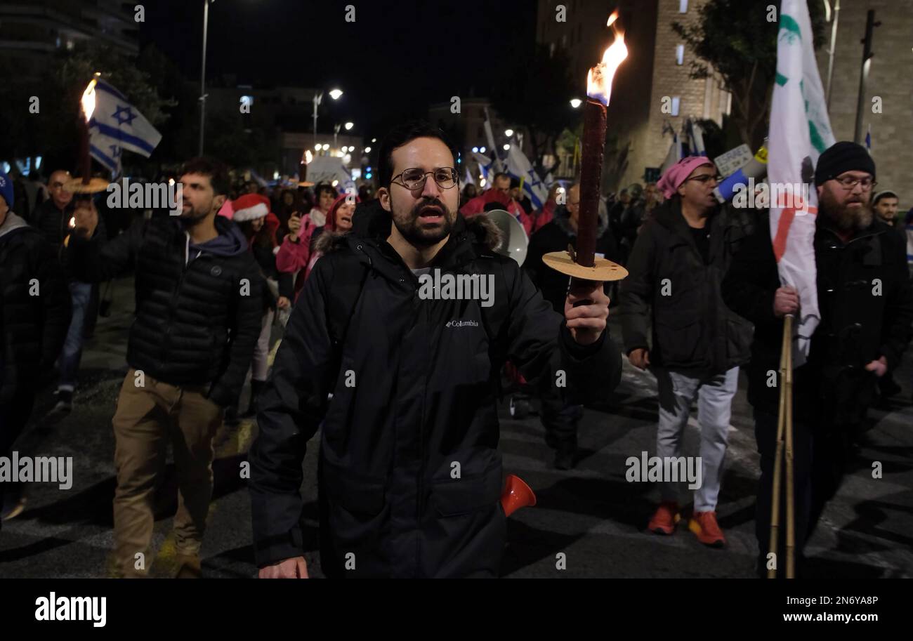 JERUSALEM, ISRAEL - FEBRUARY 9: Anti-government protesters hold torches ...
