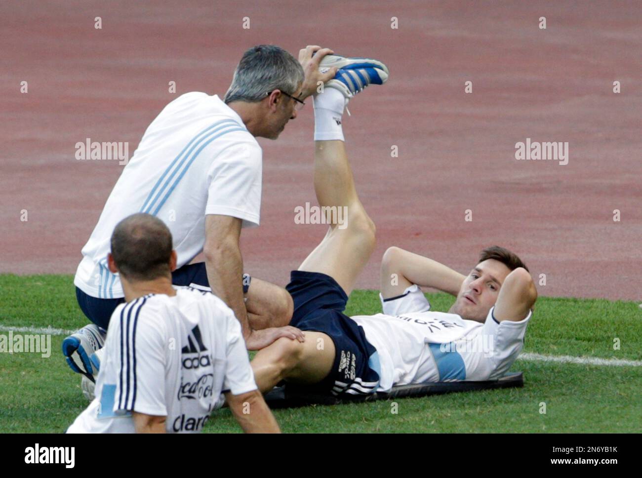 Argentine forward Lionel Messi stretches during a training session at ...