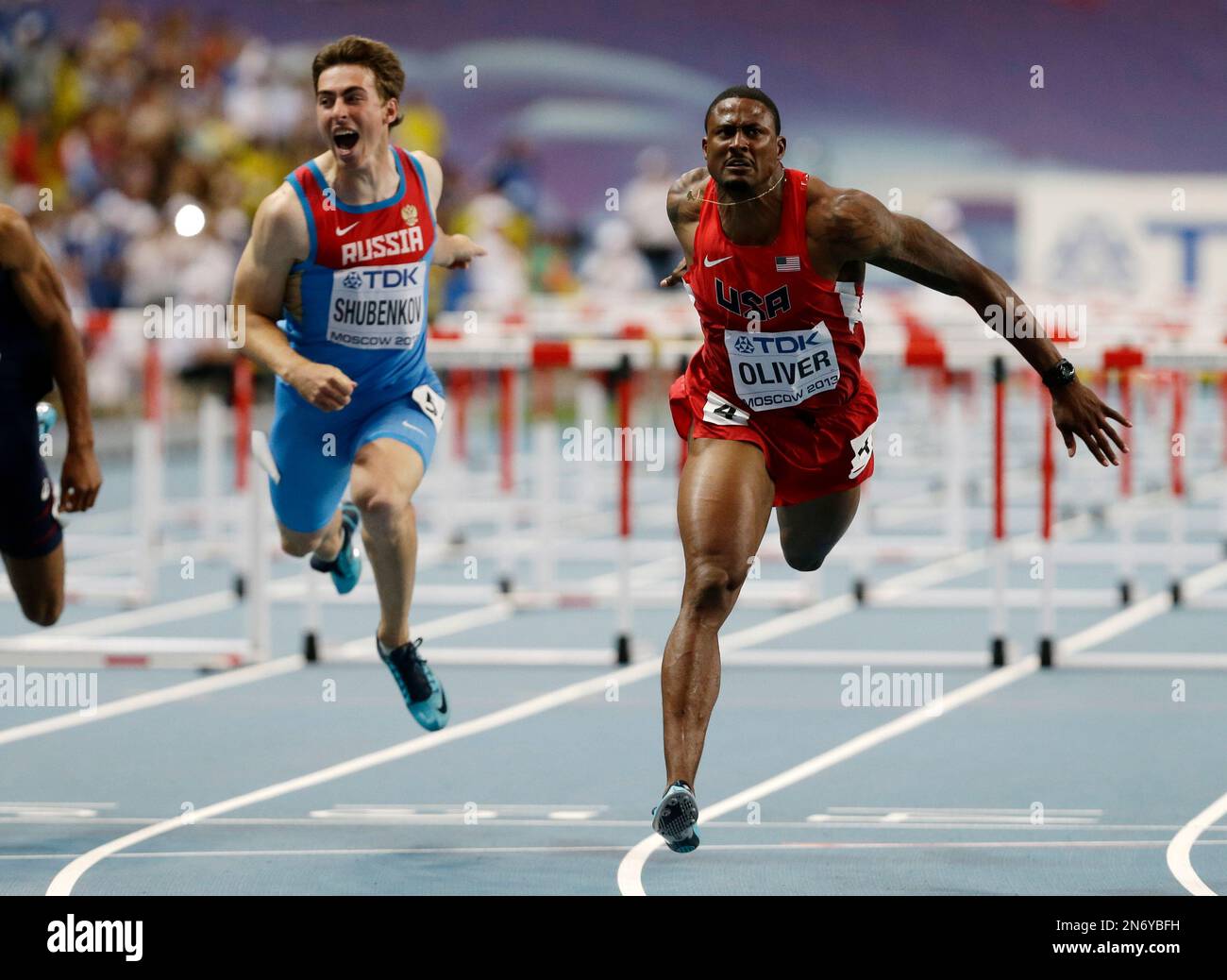 United States' David Oliver, right, crosses the finish line ahead of ...