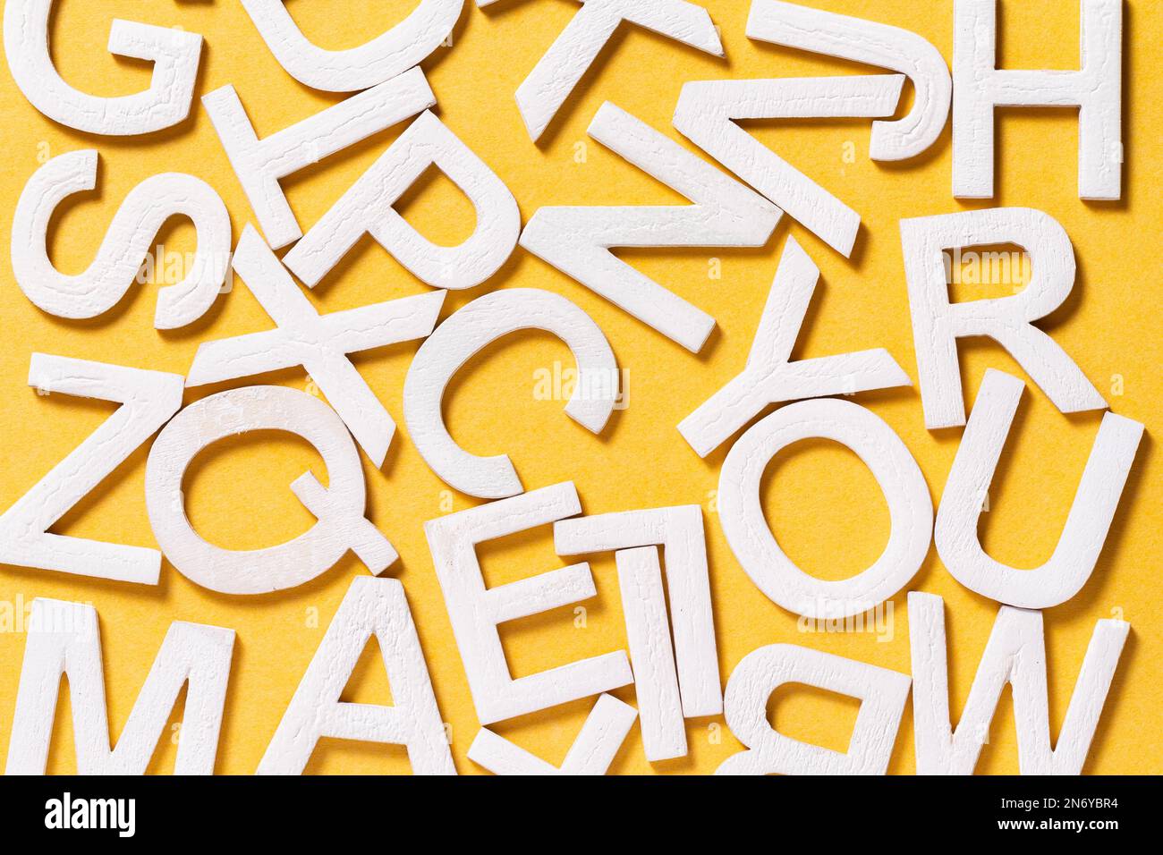 Set of letters of the alphabet in disorder, on yellow background, top ...