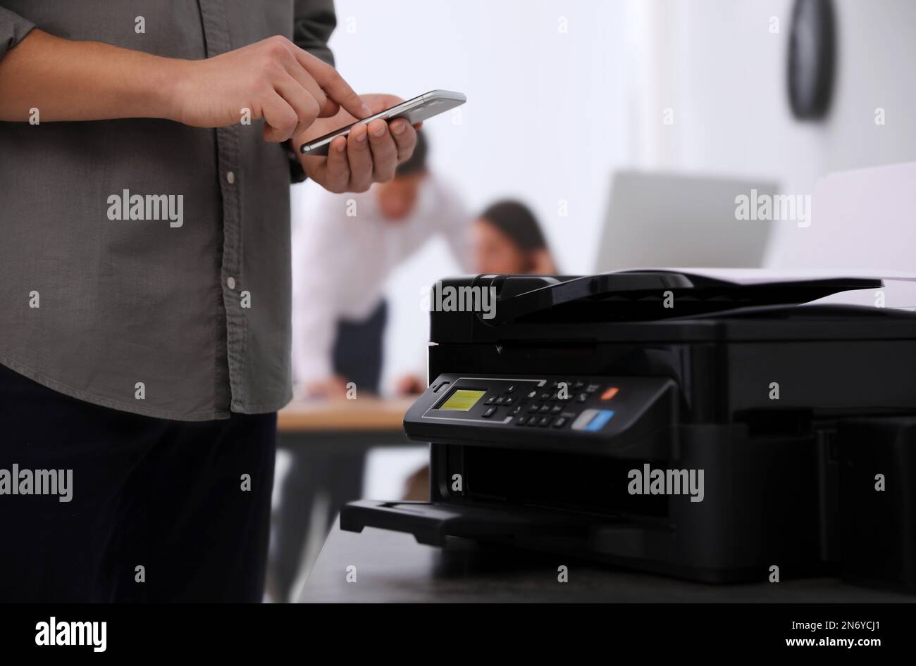 Employee using modern printer in office, closeup Stock Photo - Alamy