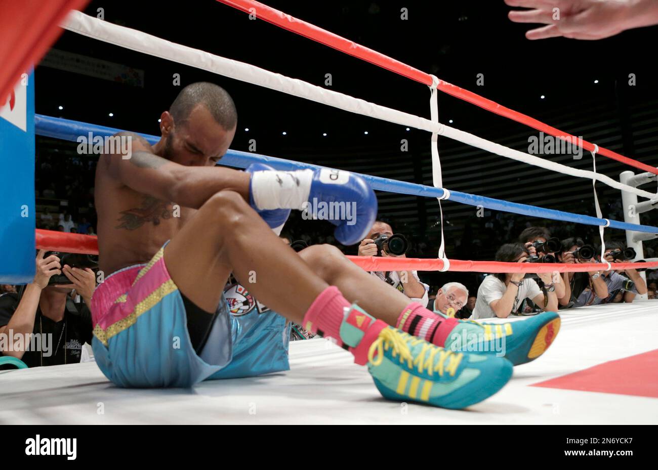 Challenger Jose Nieves of Puerto Rico sits on the canvas after he was ...