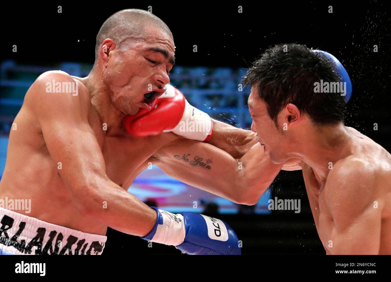 Japanese champion Akira Yaegashi, right, lands his right to challenger ...