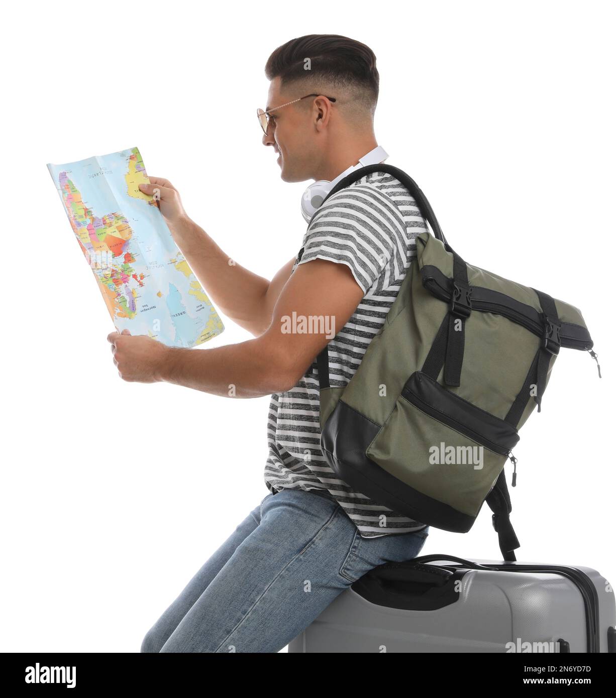 Man with suitcase and backpack reading map on white background. Summer ...