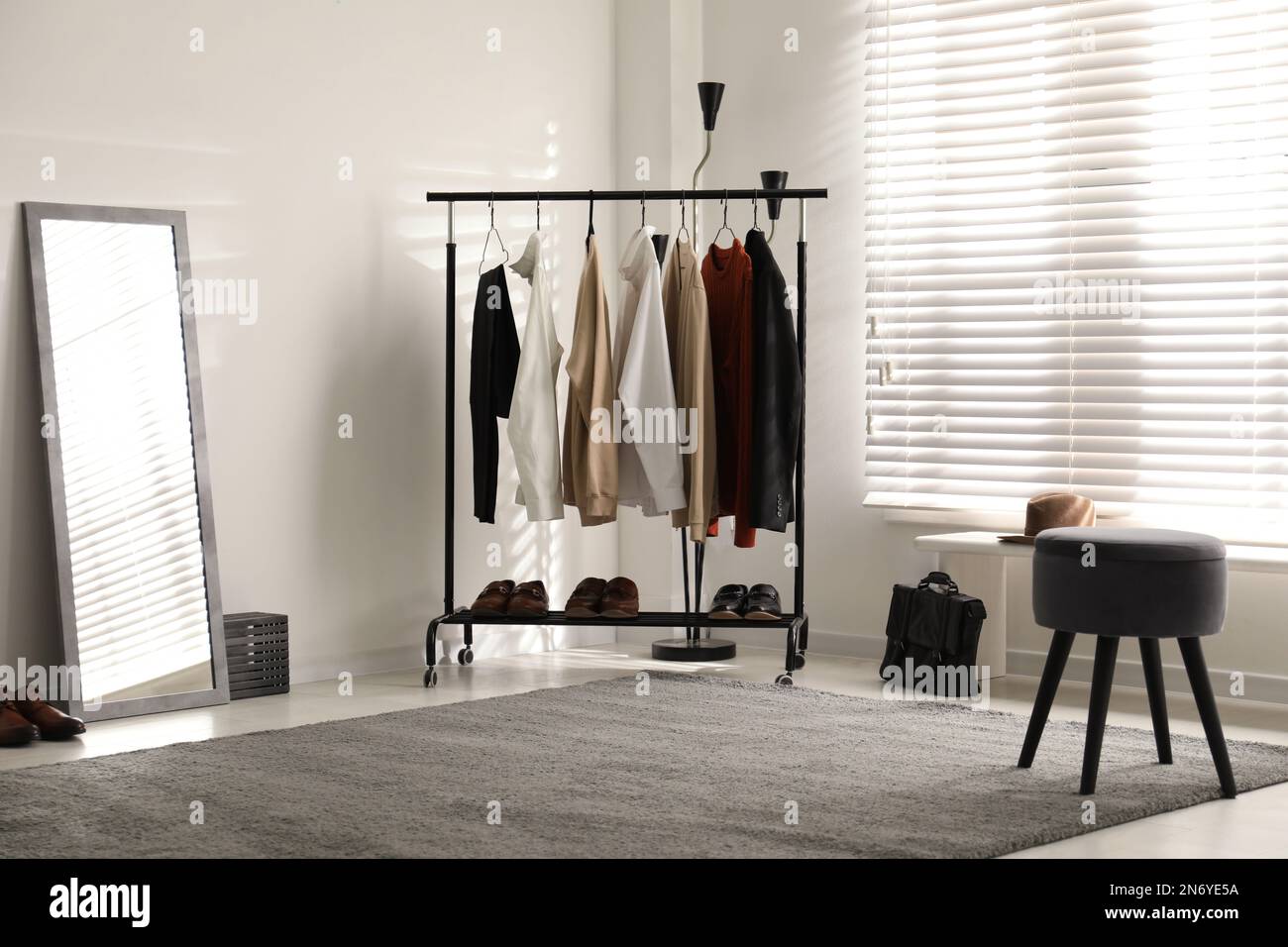 Dressing room interior with clothing rack and mirror Stock Photo - Alamy