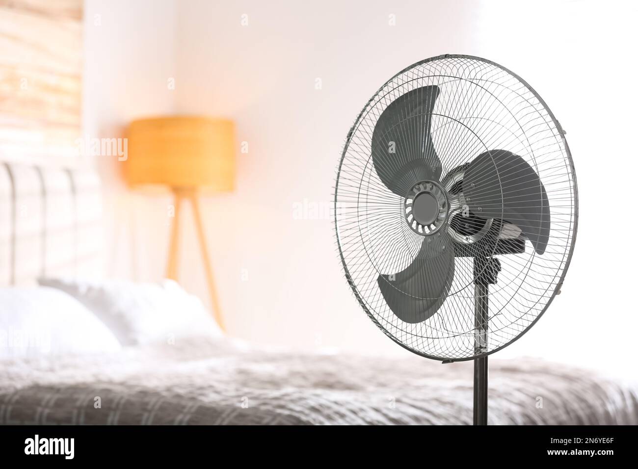 Modern electric fan in bedroom. Space for text Stock Photo - Alamy