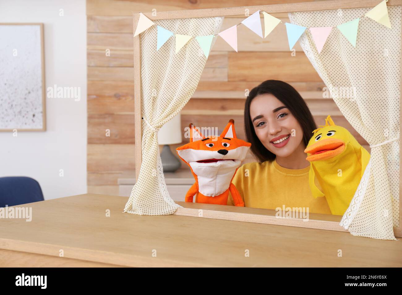Young woman performing puppet show at home Stock Photo - Alamy