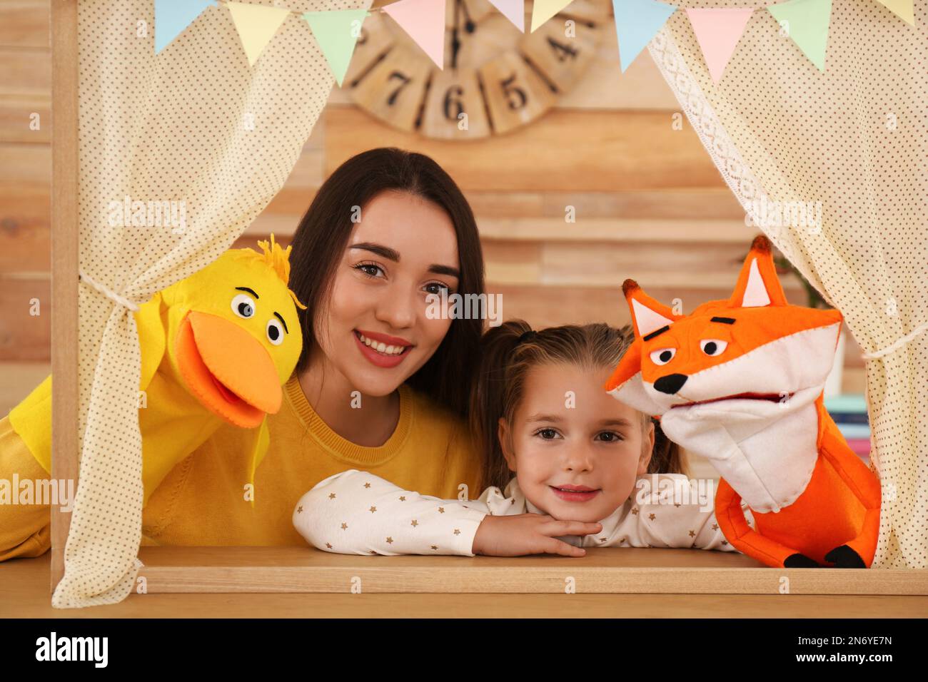 Mother and daughter performing puppet show at home Stock Photo - Alamy