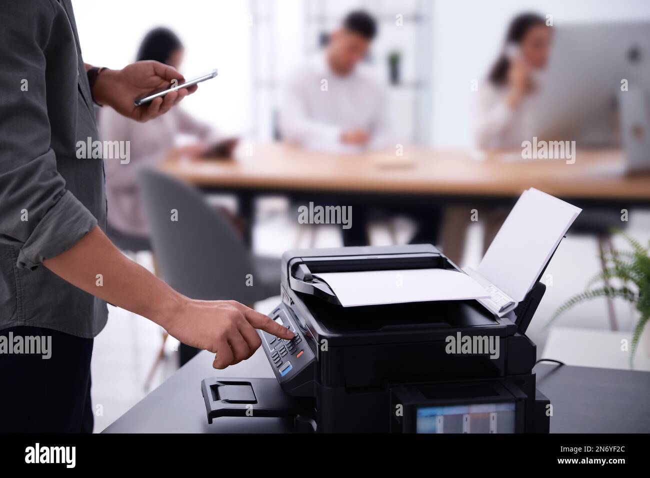 Employee using modern printer in office, closeup Stock Photo - Alamy