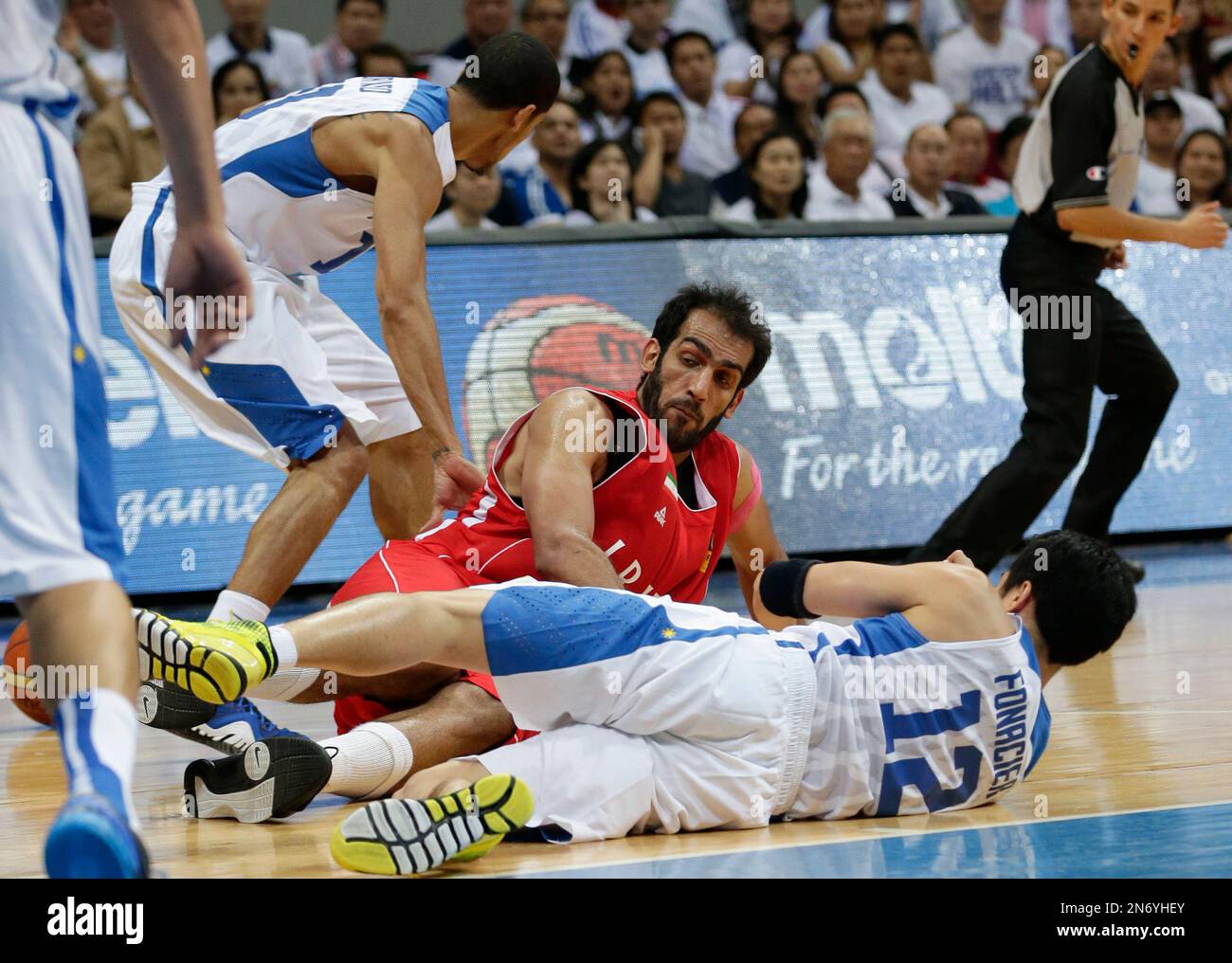 Iran's Hamed Hadadi, center, and the Philippines Larry Alexander ...