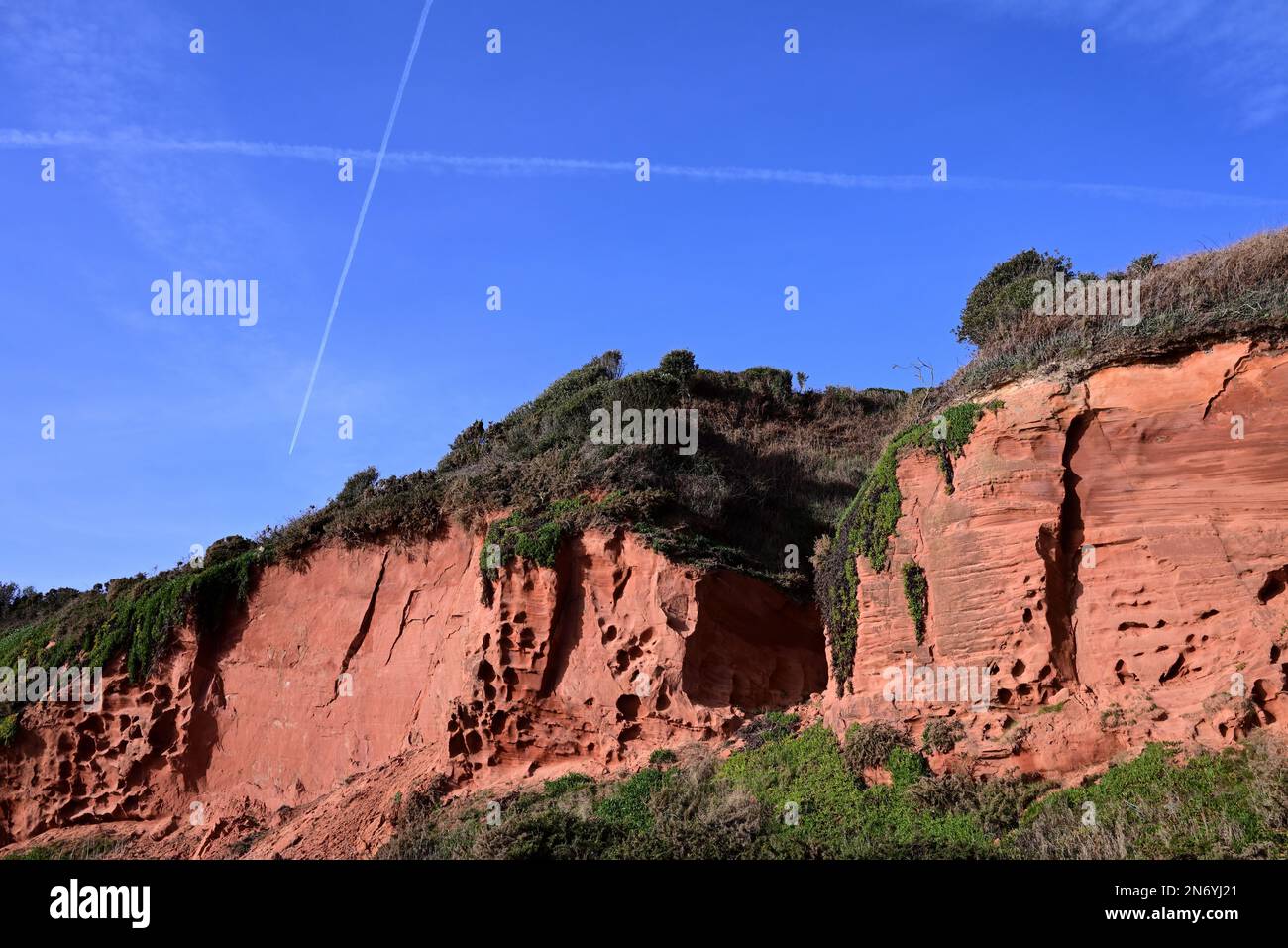 Red sandstone cliffs beside the coastal railway line at Dawlish, South ...