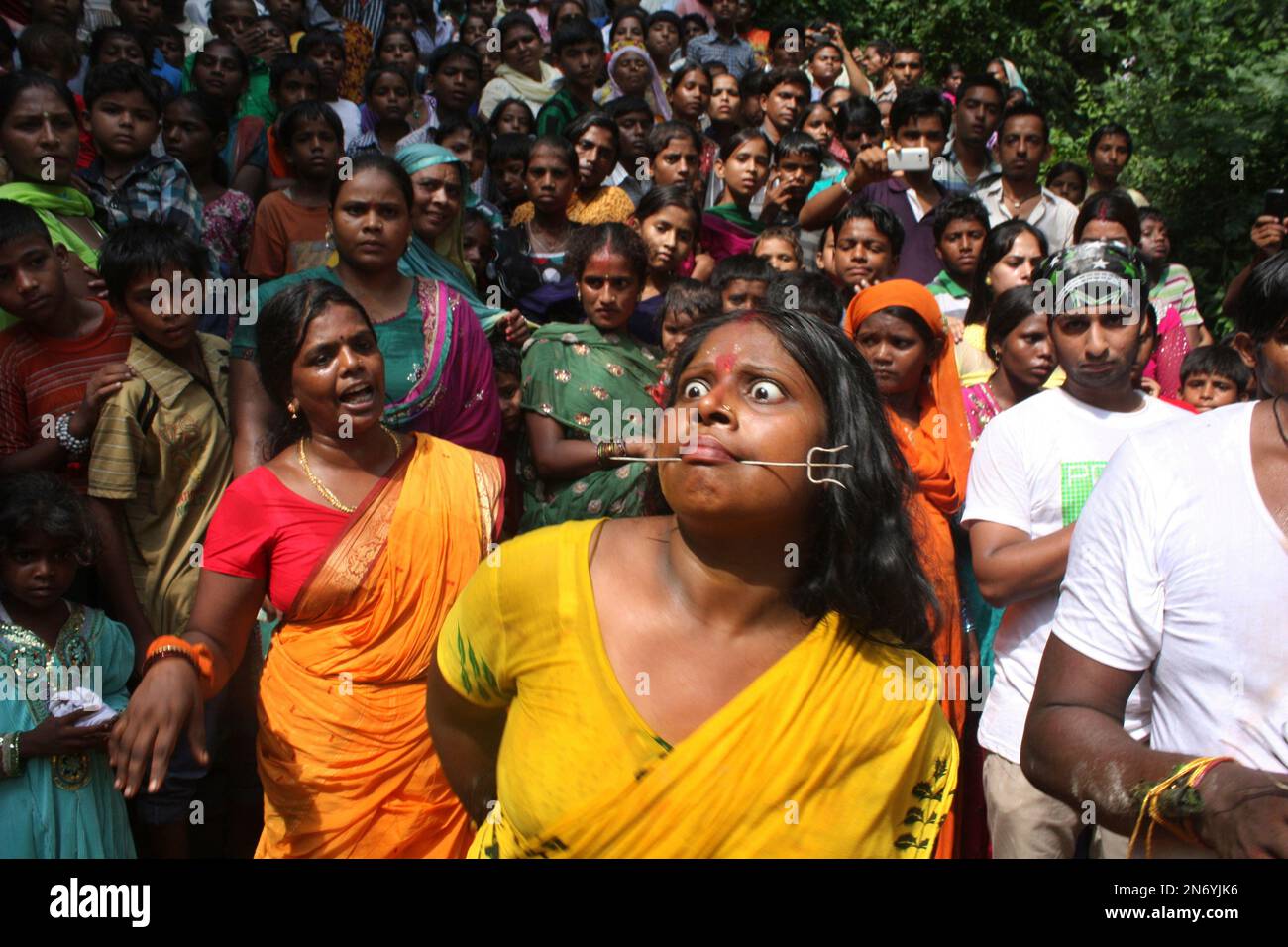 An Indian Hindu devotee dances in trance after getting her tongue ...