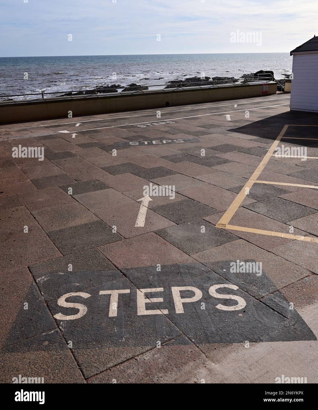 Warning signs about partly hidden steps along the seafront at Dawlish ...