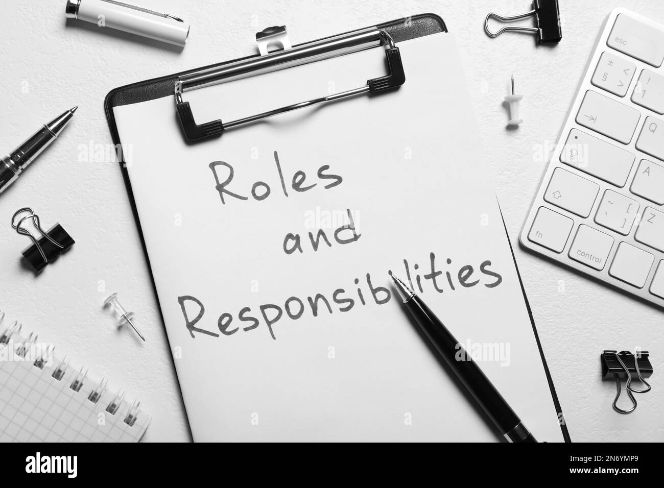 Clipboard with sheet of paper saying Roles and Responsibilities among ...