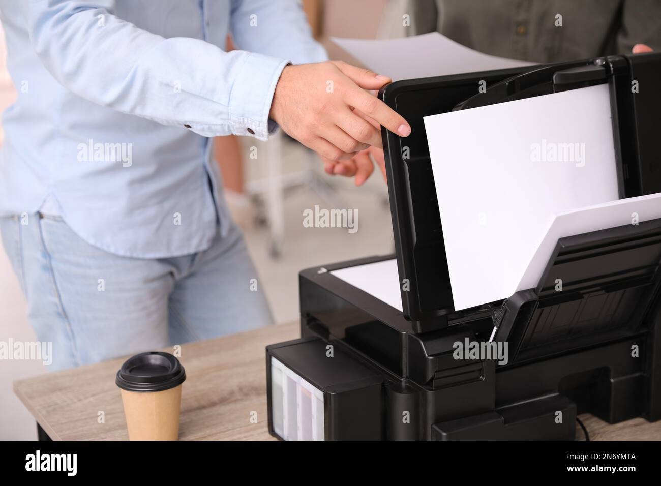 Employee using modern printer in office, closeup Stock Photo - Alamy