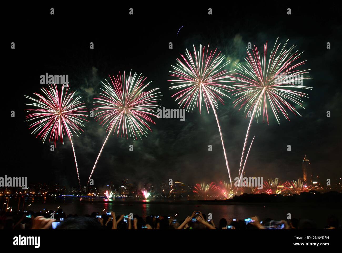 Fireworks illuminate the sky over the Tamsui River during the Taipei ...