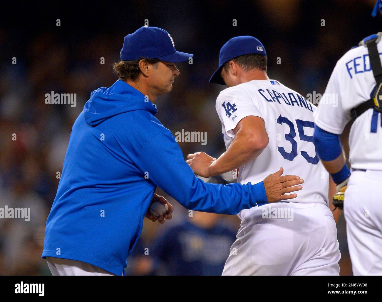 Los Angeles Dodgers manager Don Mattingly, left, takes starting pitcher Chris Capuano out of the ...