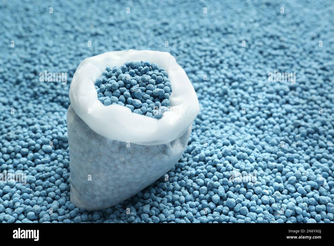 Bag and granular mineral fertilizer, closeup with space for text Stock ...