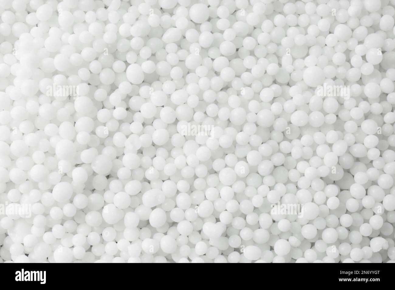 Pellets of ammonium nitrate as background, top view. Mineral fertilizer ...