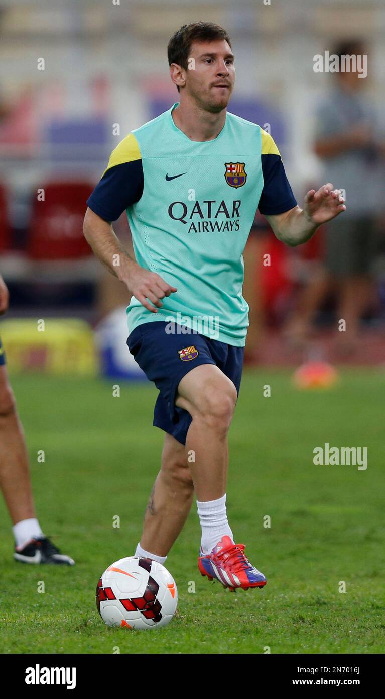 FC Barcelona’s Lionel Messi warms up during a training session at Bukit ...