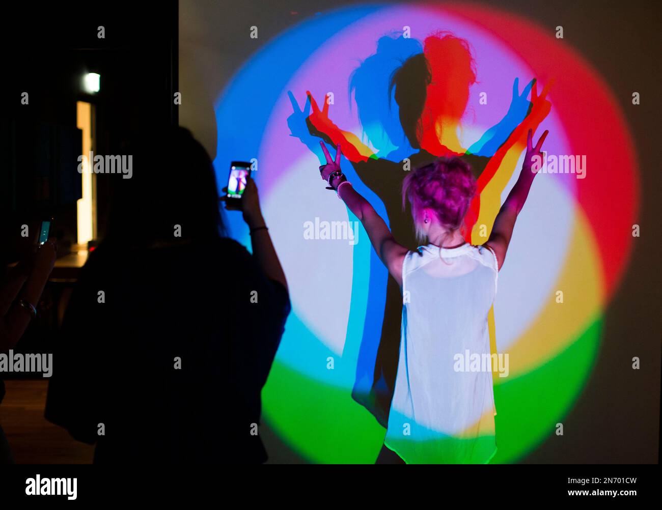 Visitors take pictures of each others in spectral colors at the ...