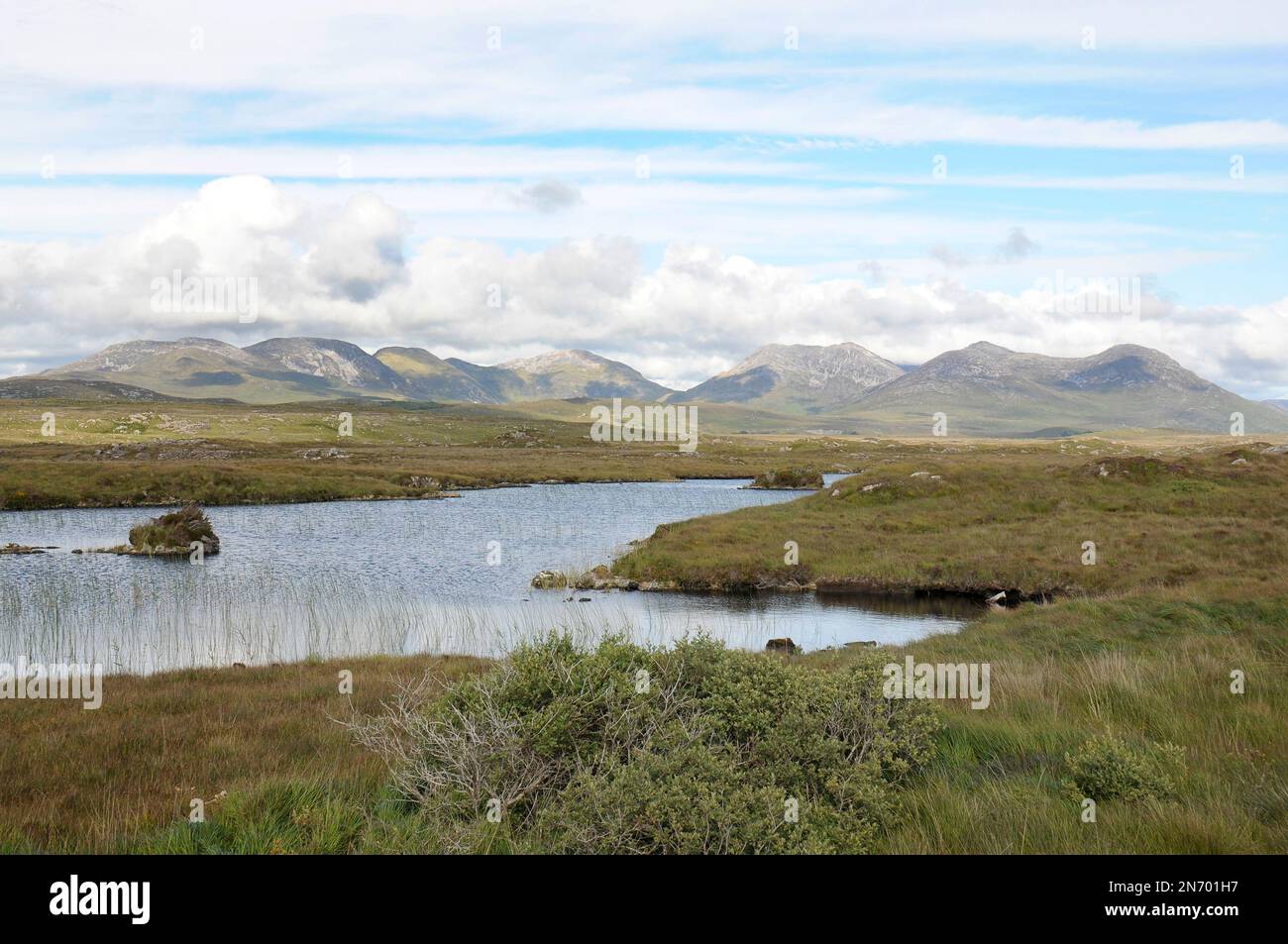 bog road in Connemara with the Twelve Pins from Lough Cloonagat on the ...