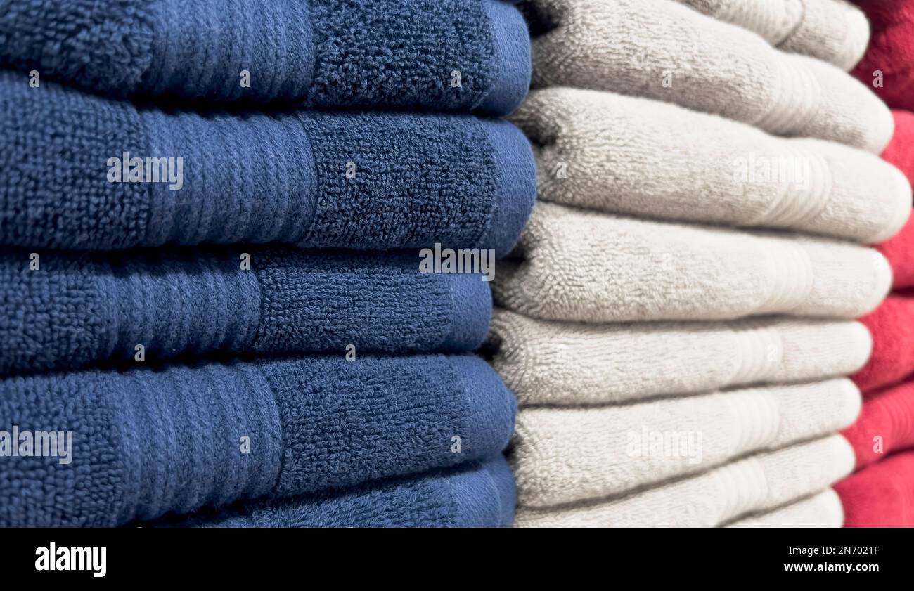 Stack of colorful towels. Fresh new fluffy towels. Pile stacked colored ...