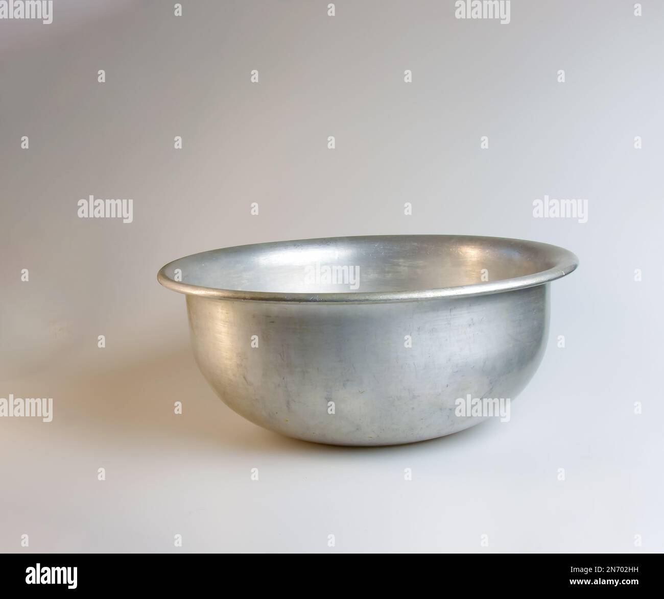 An old aluminum bowl made in circa 1960 against a white background ...