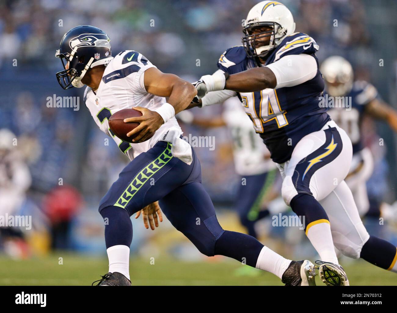 Seattle Seahawks quarterback Russell Wilson escapes the grasp of San ...