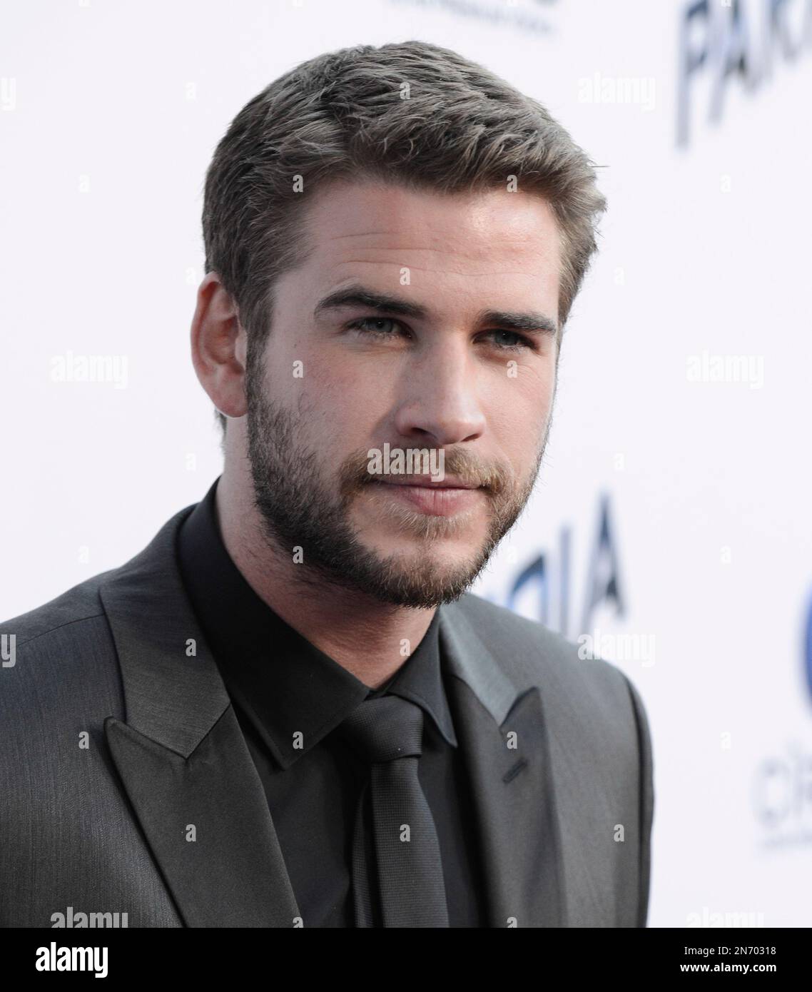 Actor Liam Hemsworth arrives on the red carpet at the US premiere of ...