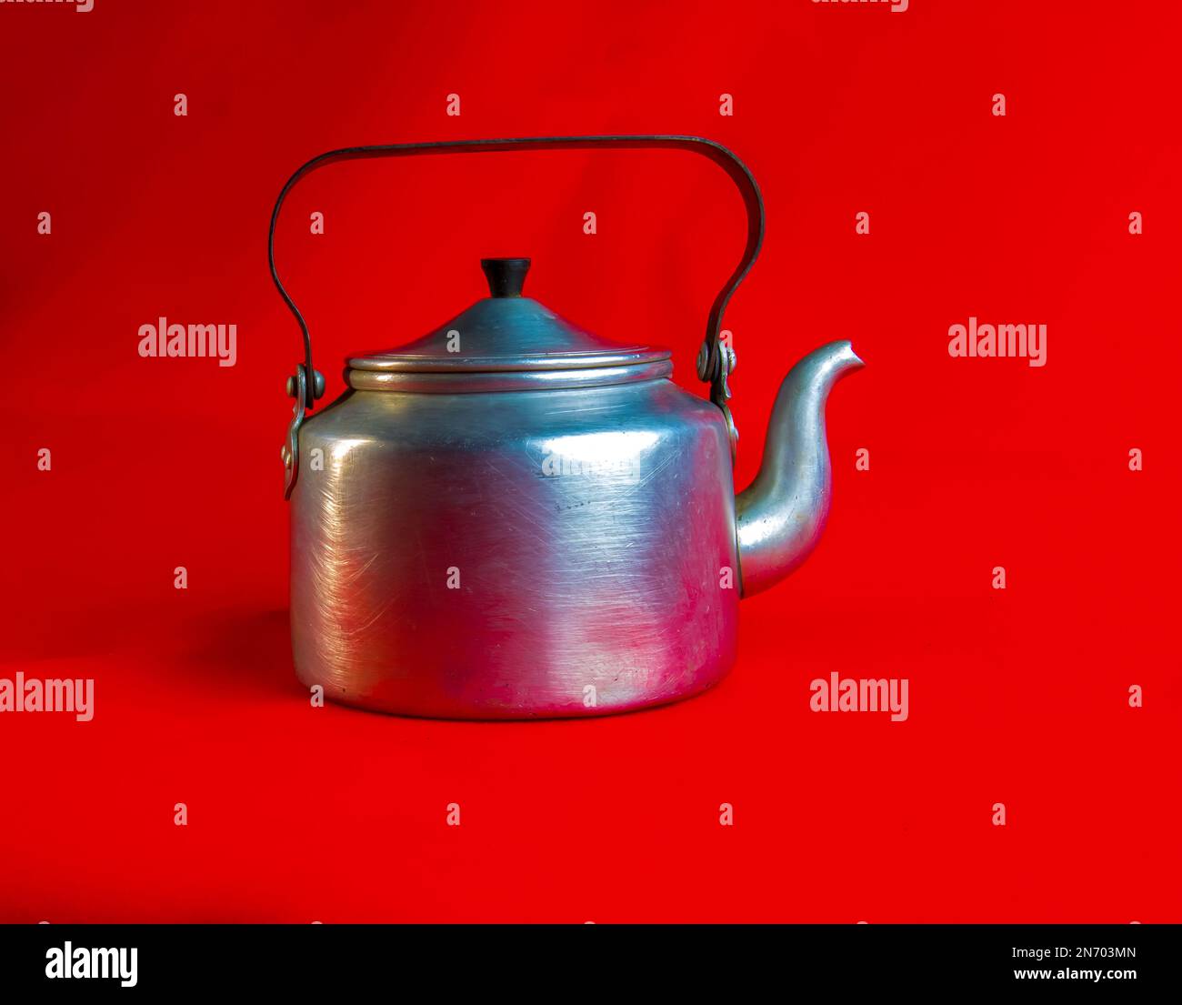 Old soldier's aluminum teapot from the Second World War on a red ...