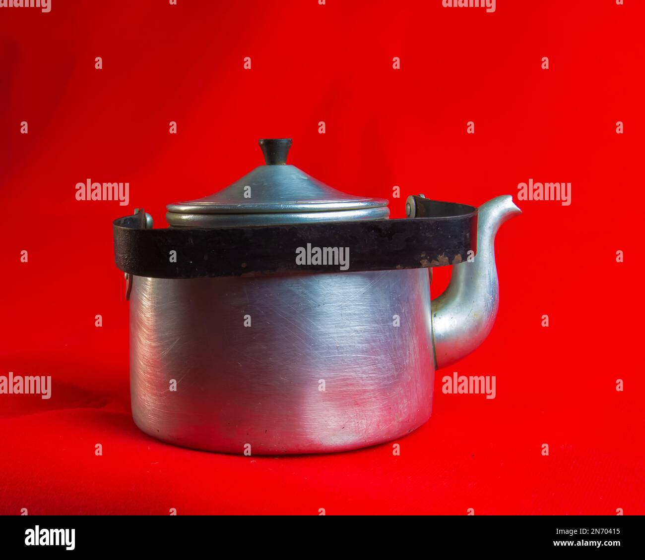Old soldier's aluminum teapot from the Second World War on a red ...