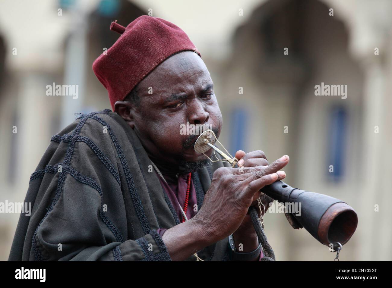 A Nigeria muslim blows a horn during Eid al-Fitr celebration in ...
