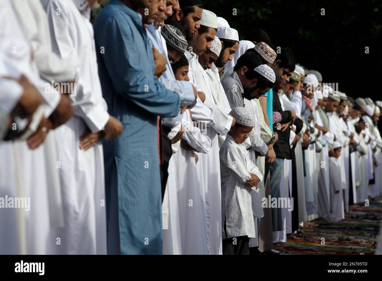 Muslims attend the the Eid al-Fitr dawn prayers marking the end of the ...