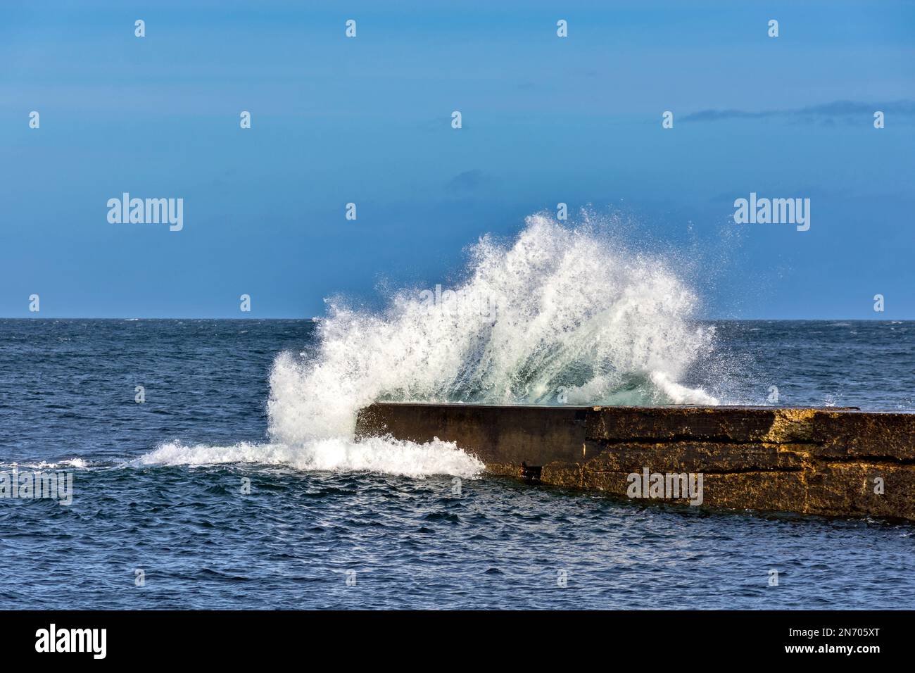 Sandend Village Aberdeenshire Scotland spray over the breakwater on a ...
