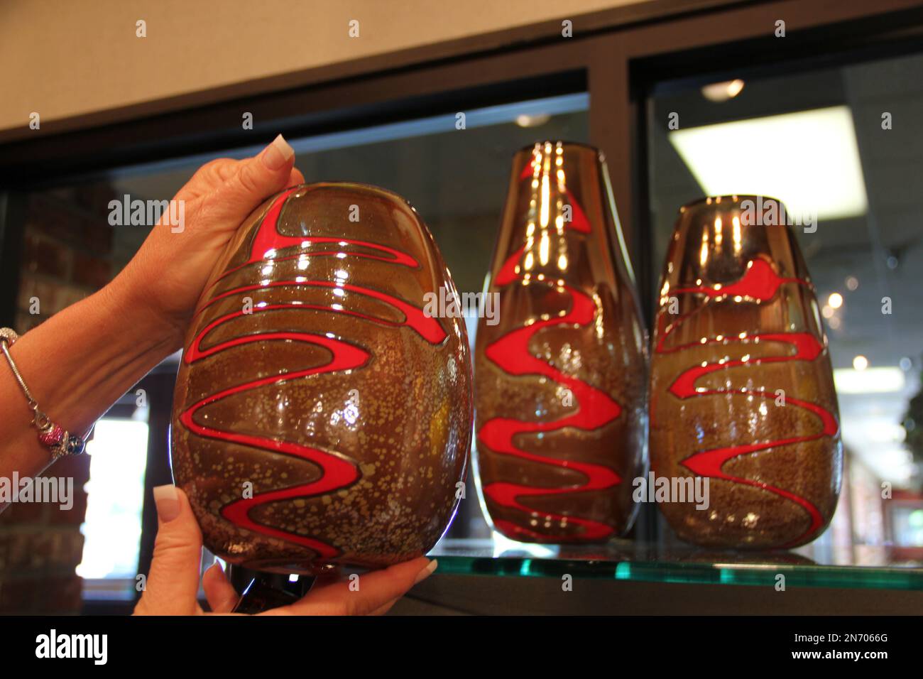 This July 16, 2013 photo shows Lisa Hemm shows vases inspired by the ...